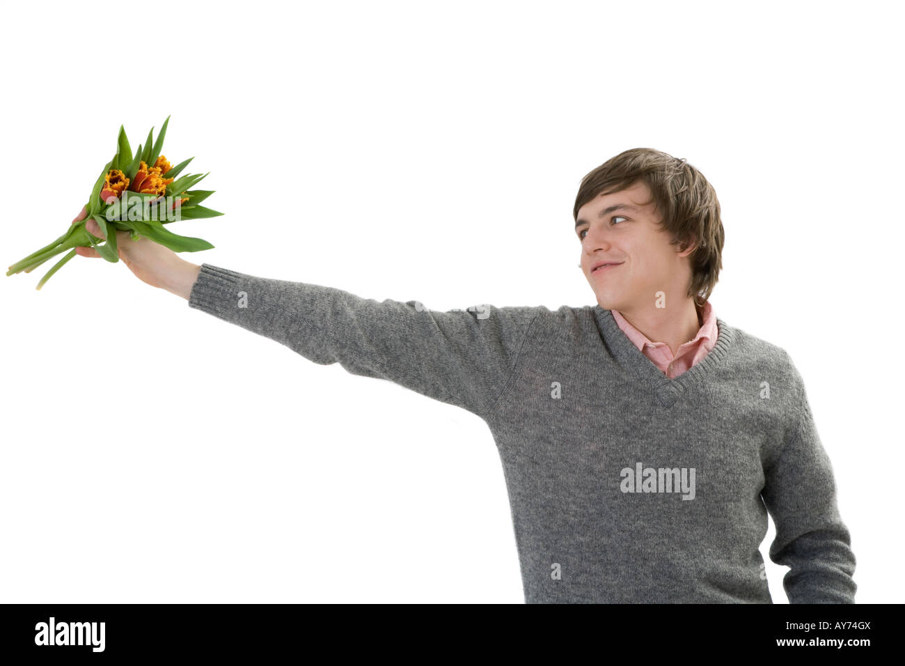 Young man offering flowers Stock Photo - Alamy