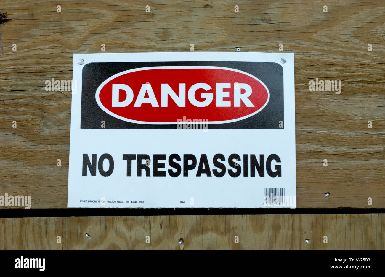 Sign on the exterior wall of a building stating danger no trespassing ...