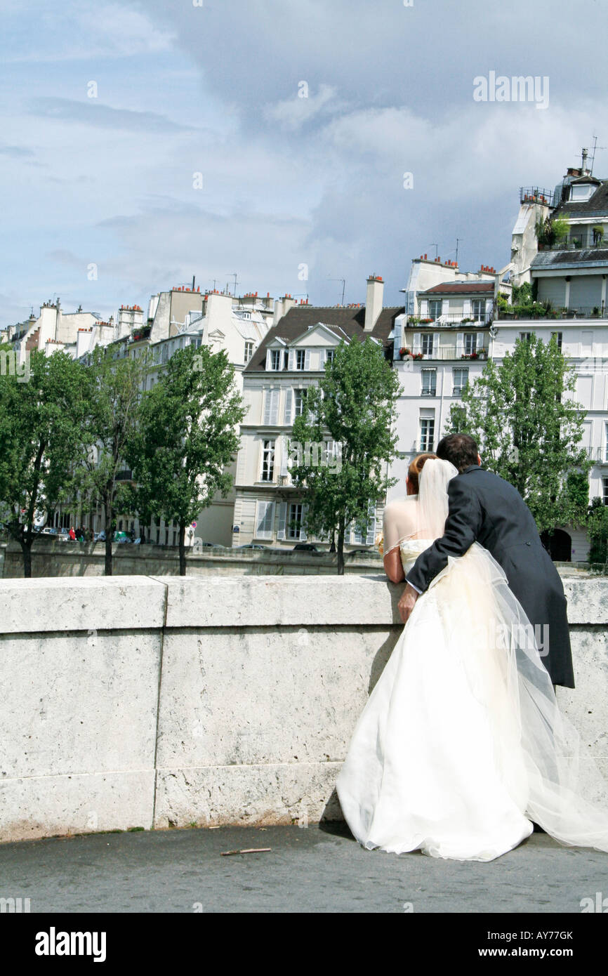 The bride and bridegroom standing on the bridge in Paris, France Stock ...