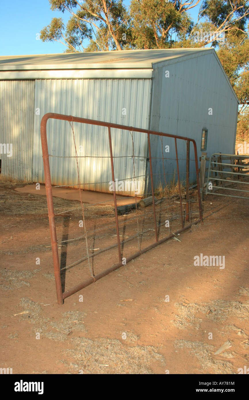 Modern shearing shed alongside disused rusting gate in Australia Stock ...