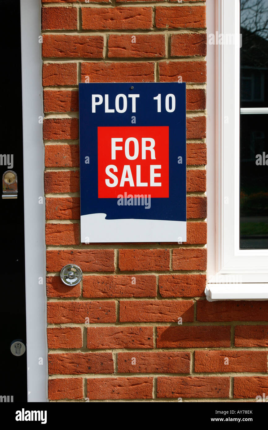 Plot for sale sign on newly built house in the UK Stock Photo - Alamy