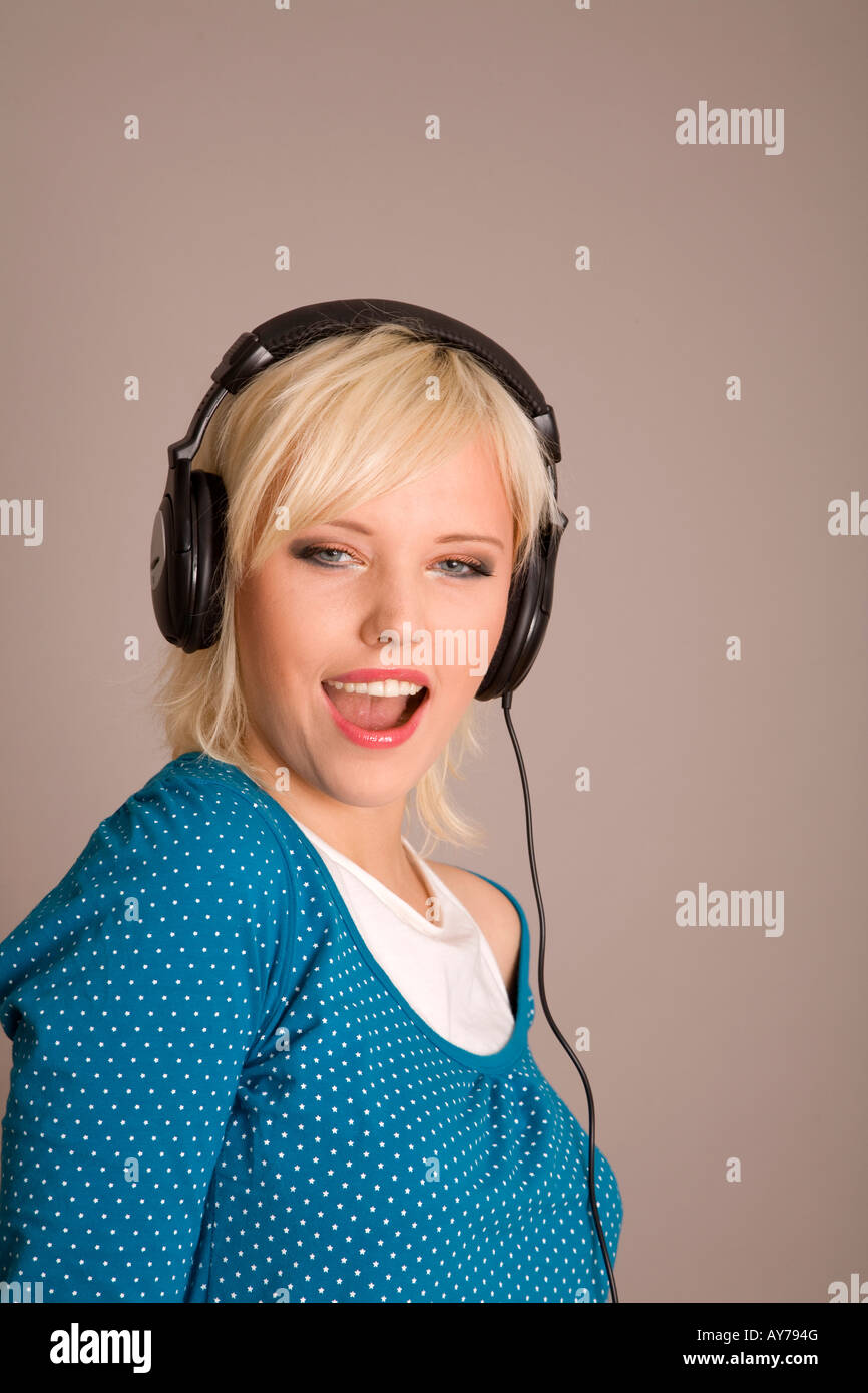 Blond woman with headphones on her head Stock Photo - Alamy