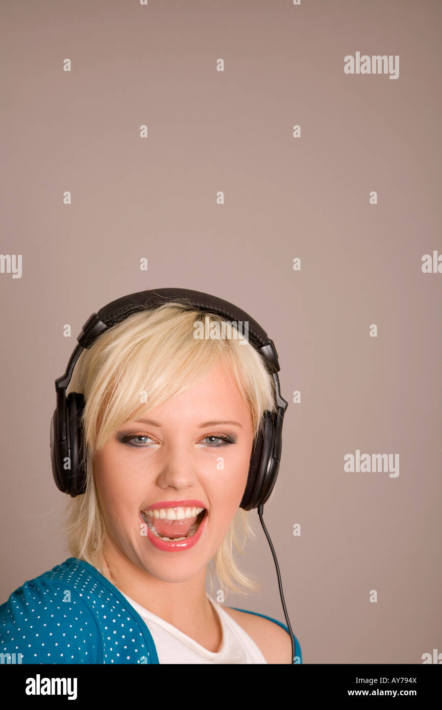 Blond woman with headphones on her head Stock Photo - Alamy