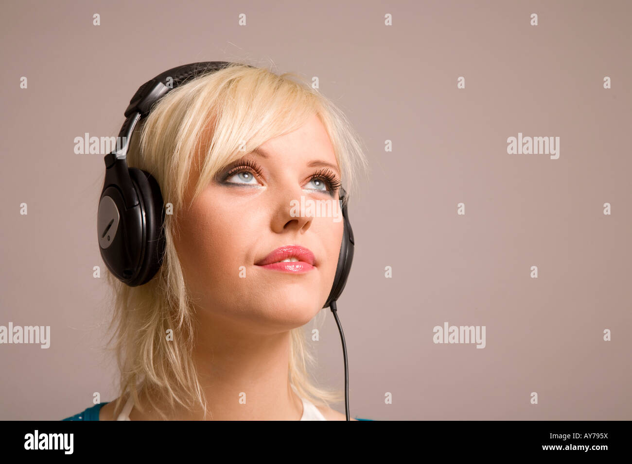 Blond woman with headphones on her head Stock Photo - Alamy