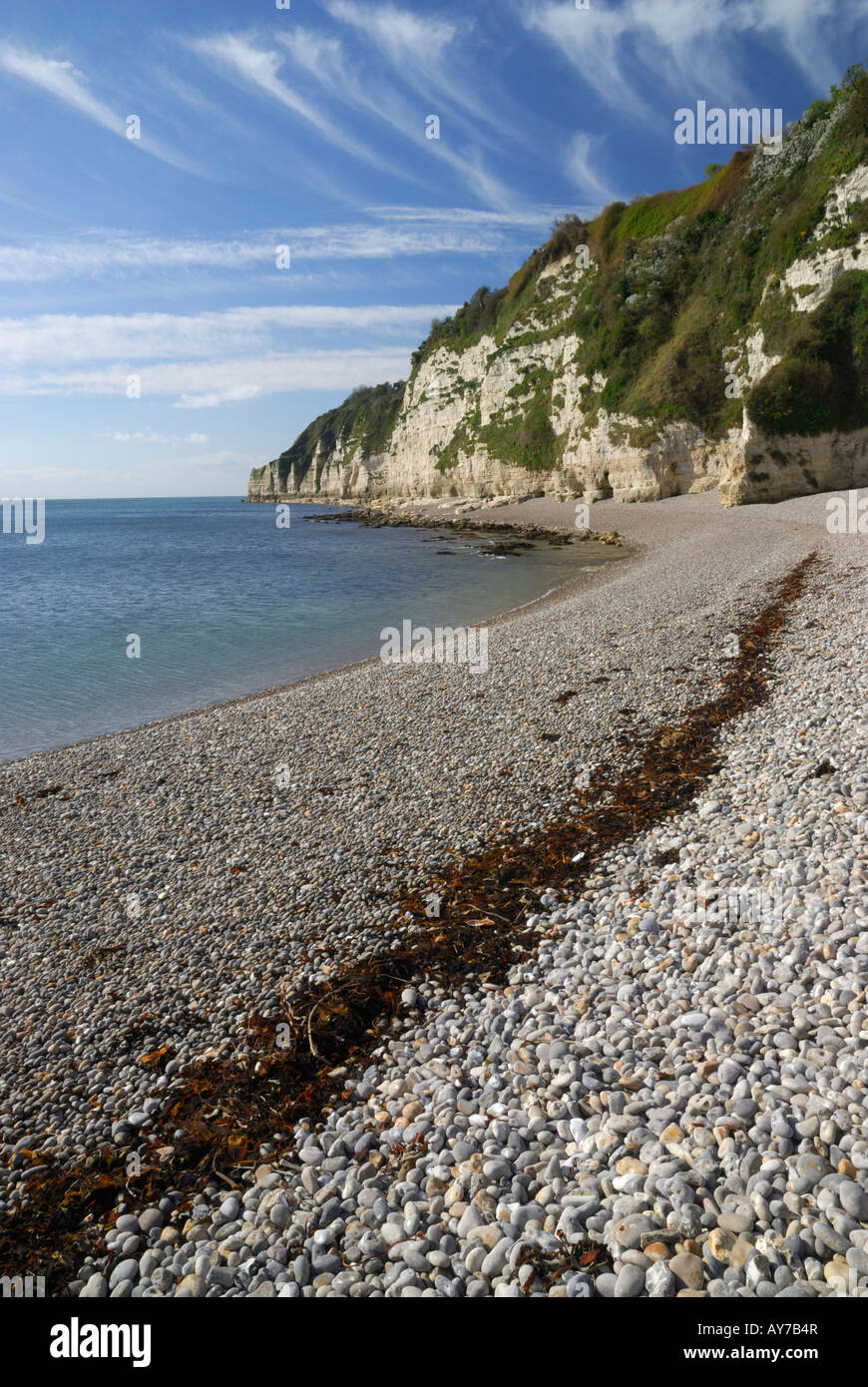 View of Beer beach, Devon, towards the cliffs with dramatic cirrus ...
