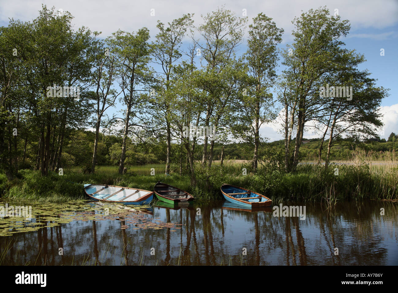 Three boats sit at the edge of Lough Melvin Kinlough county Leitrim ...