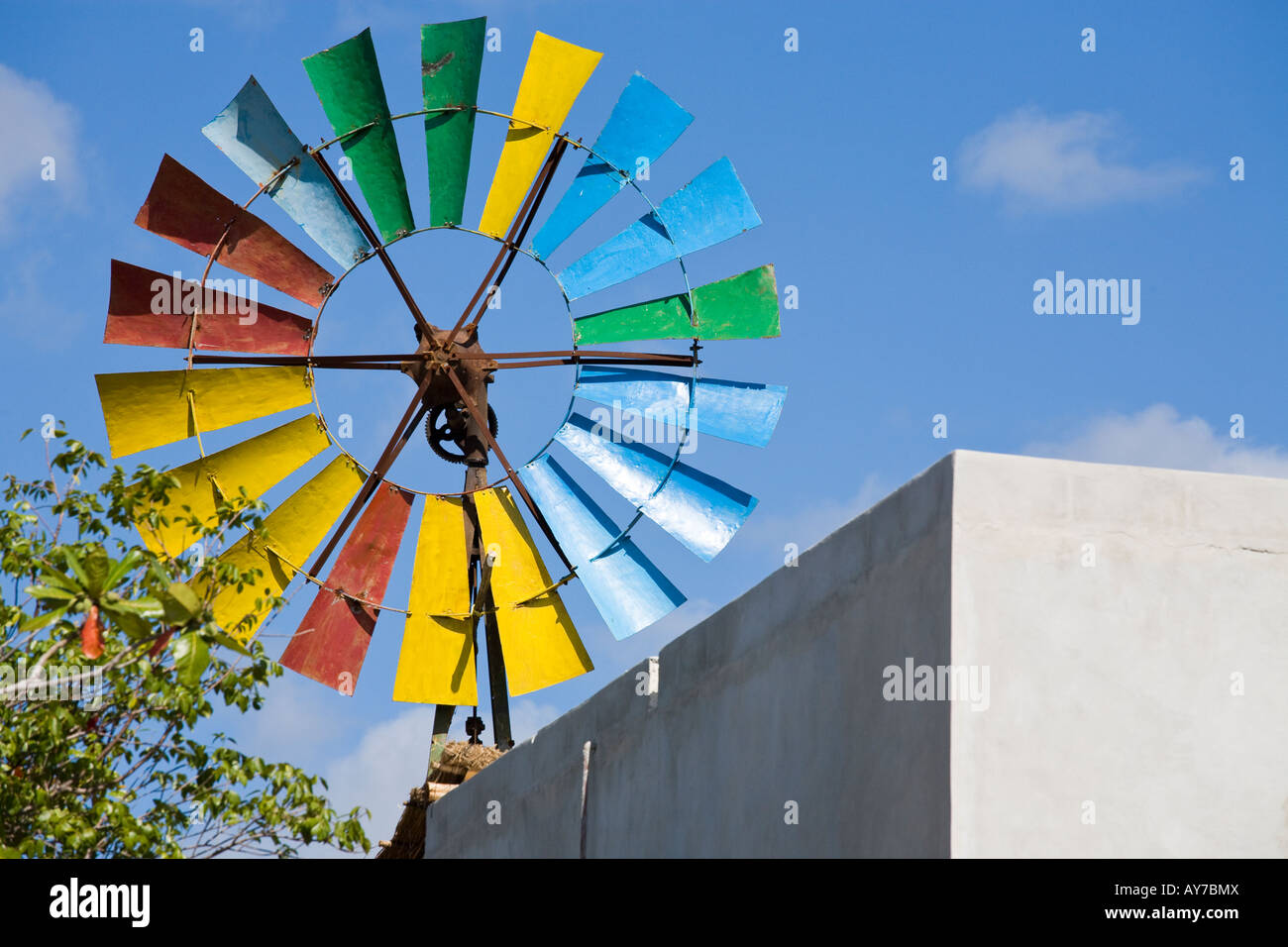 Painted Windmill An old rusted windmill rises above a plain building ...
