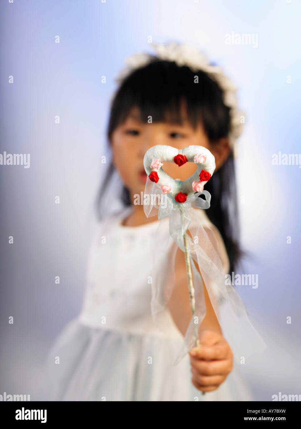 Close up of a cheerful girl showing her magic stick Stock Photo - Alamy