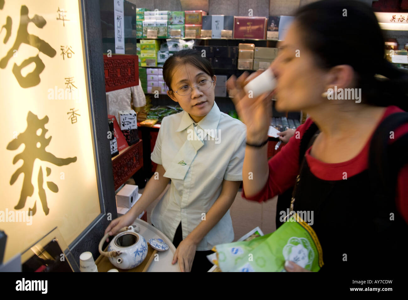European woman is tasting tea in the WUYUTAI Tea Shop in Beijing Stock ...