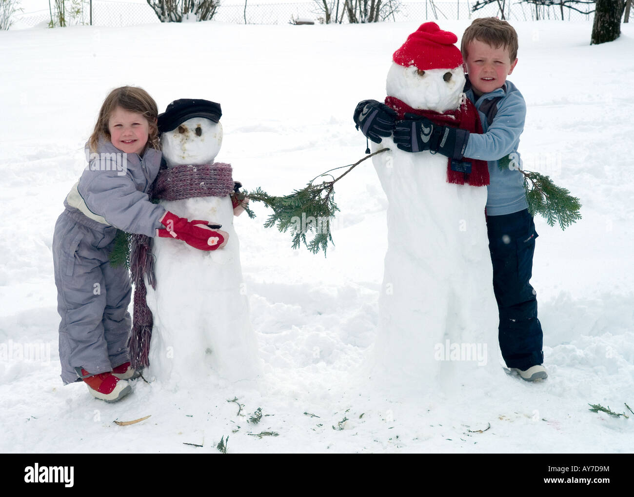 Children with snowman Stock Photo - Alamy