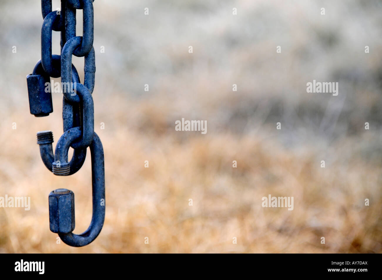 A chain, hanging in wait, weathering the elements without complaint ...