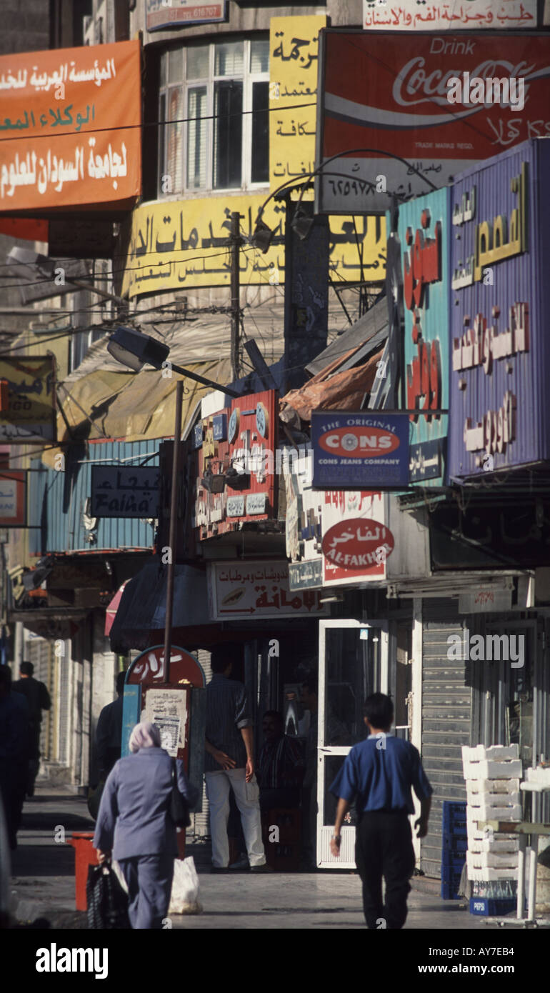 Signs and posters above pedestrians on downtown Amman Jordan street ...