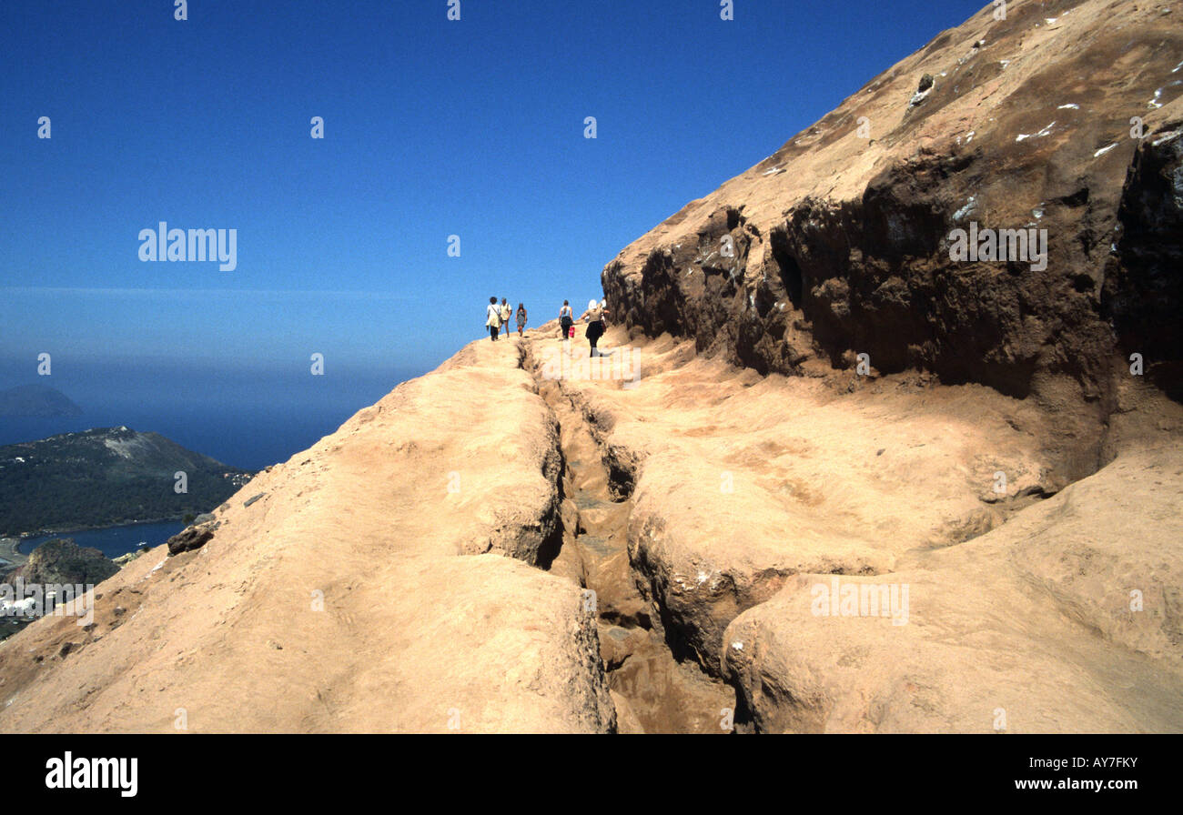 People hiking on the volcanic mountain in the island of Lipari, Sicily ...