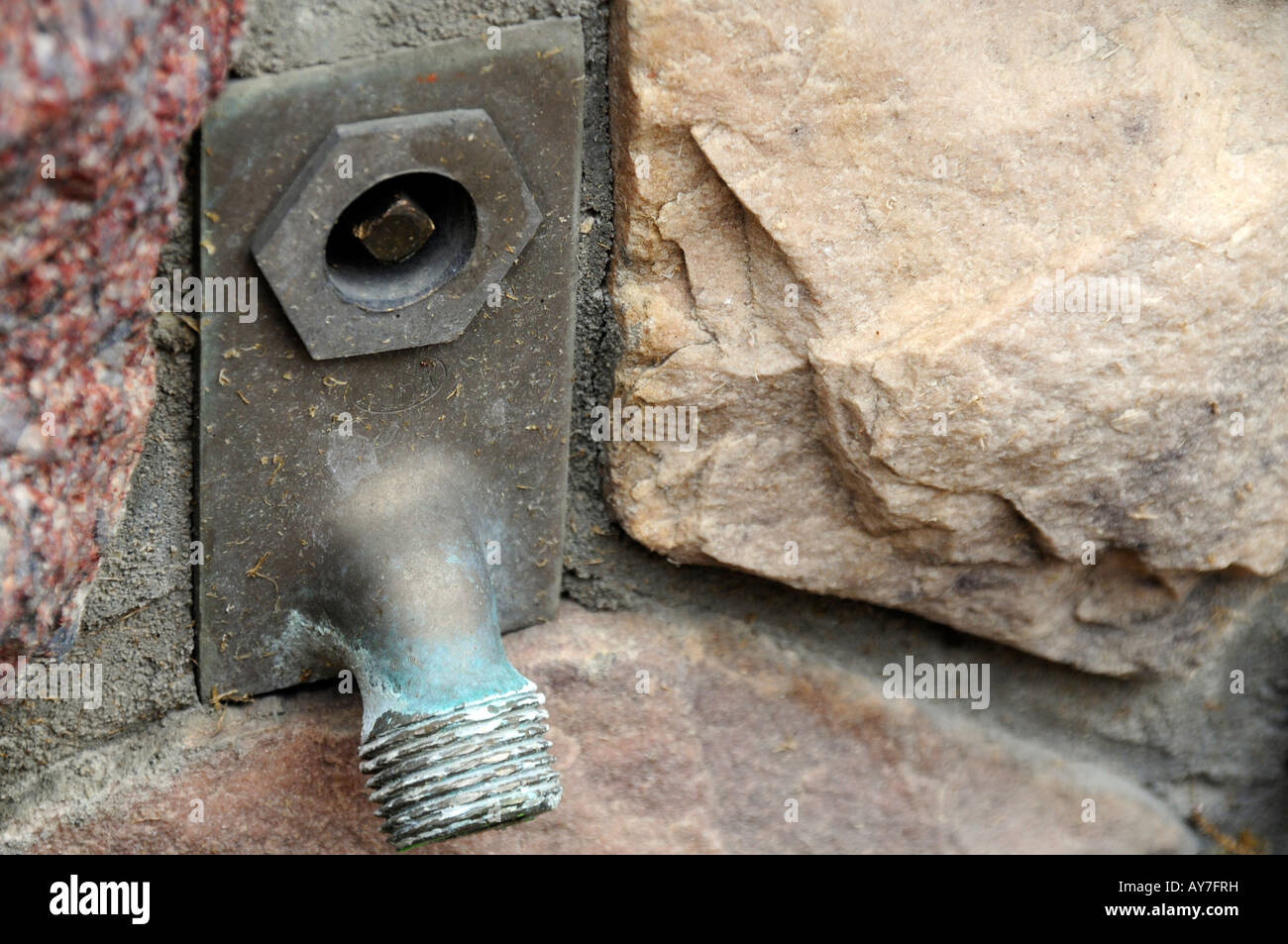 A water spout set in stone masonry, slightly weathered Stock Photo - Alamy