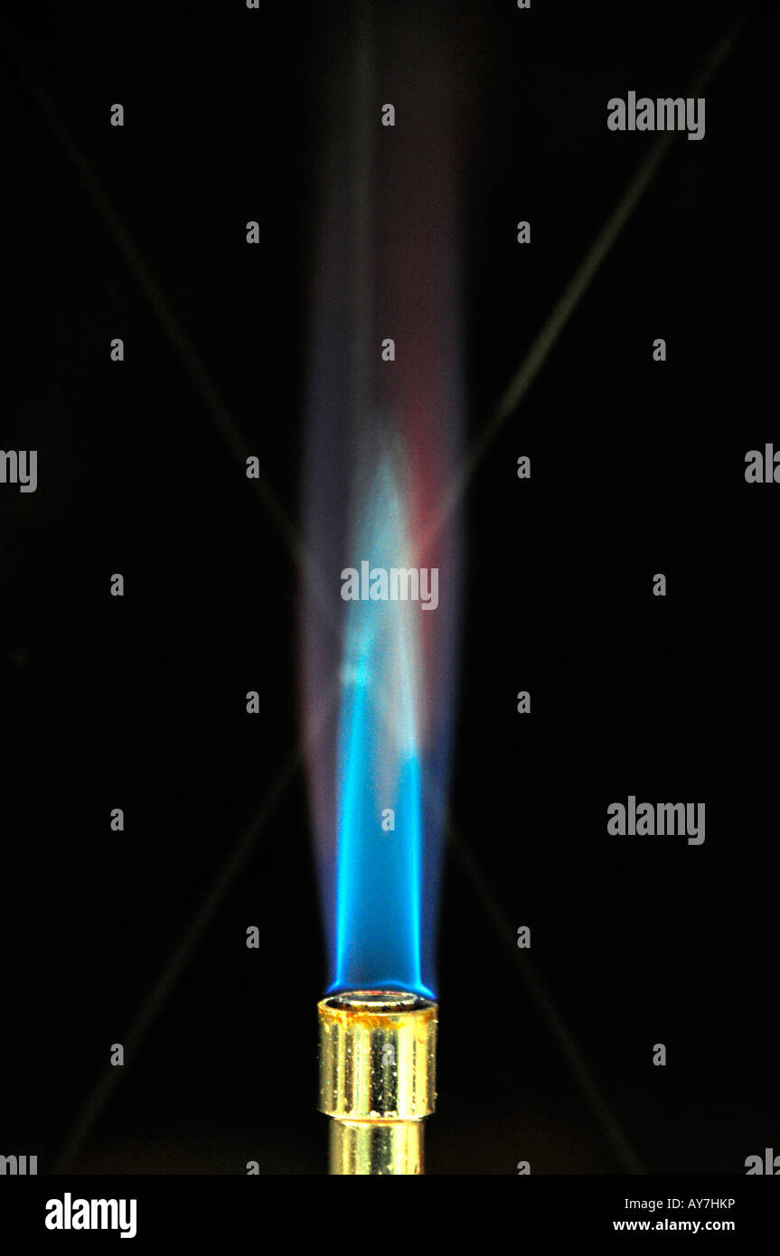 A Bunsen burner, blazing brilliantly against a black background Stock ...