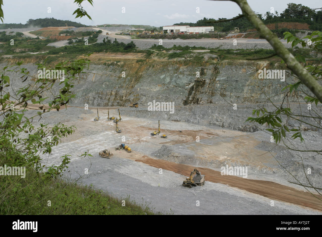 Overview of surface opencast gold mine, with drill rigs preparing for ...