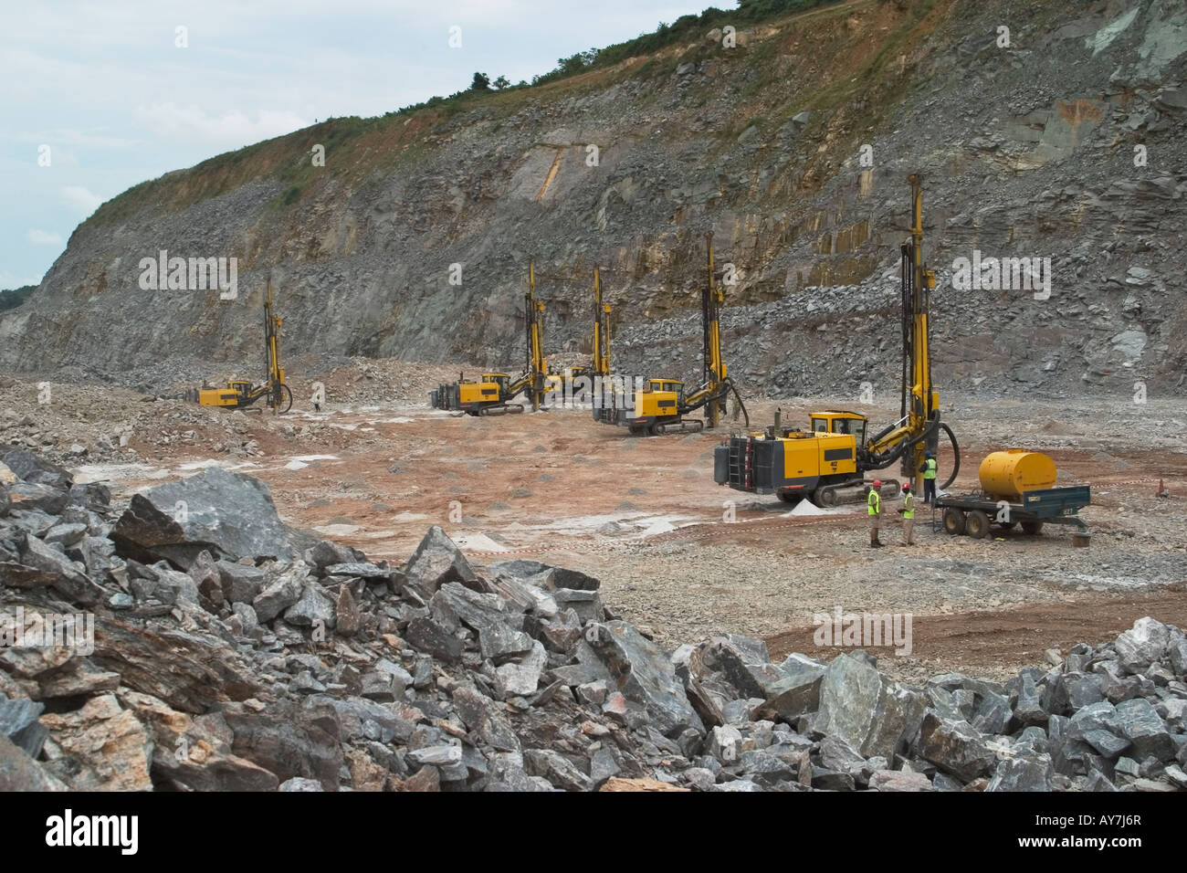 Drill rigs in opencast gold mine, preparing for blasting by drilling ...