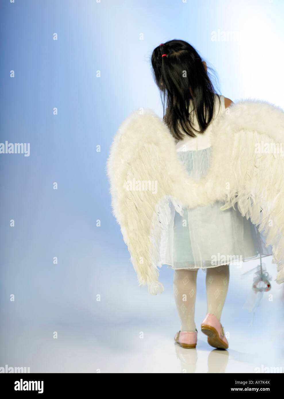 Young girl wearing angel wings, shot from behind Stock Photo - Alamy