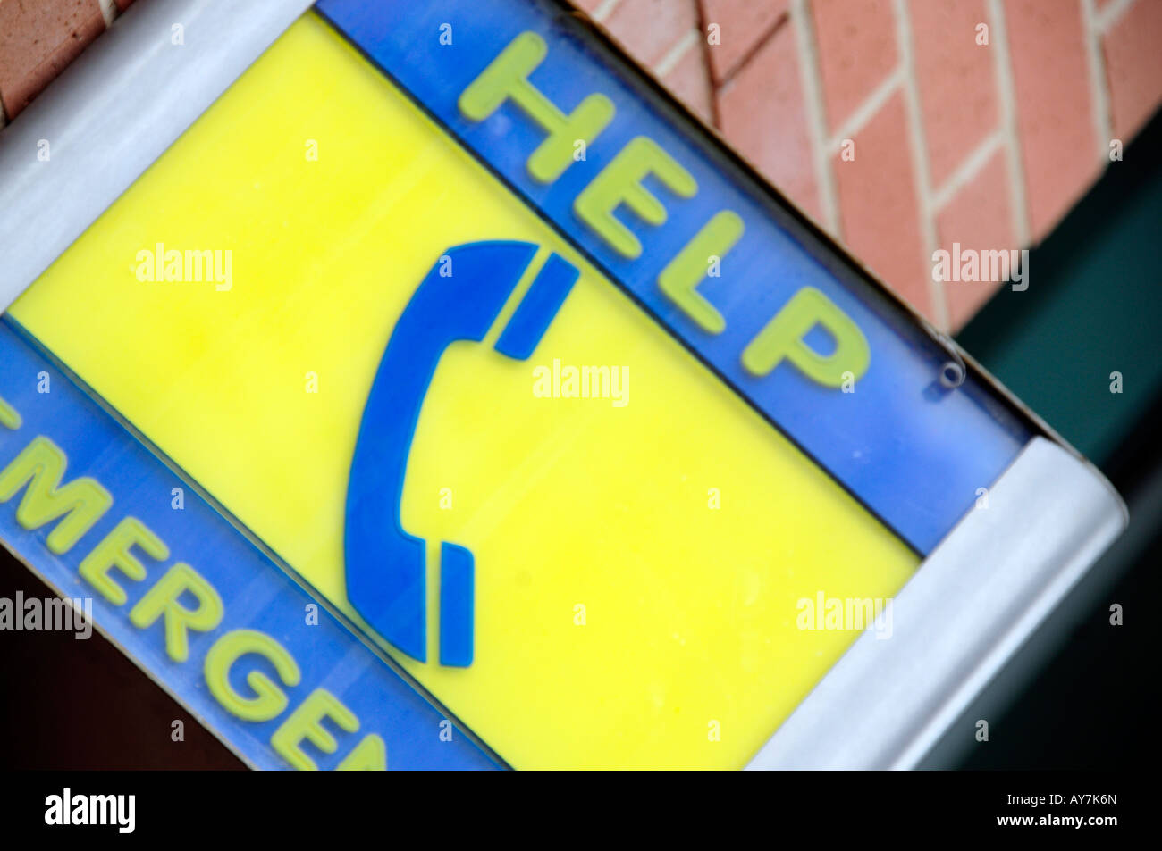 The startling blue and yellow emergency help phone sign, securely ...