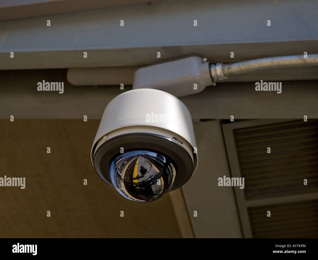 A modern security camera in a glass dome watches passengers at a Train ...