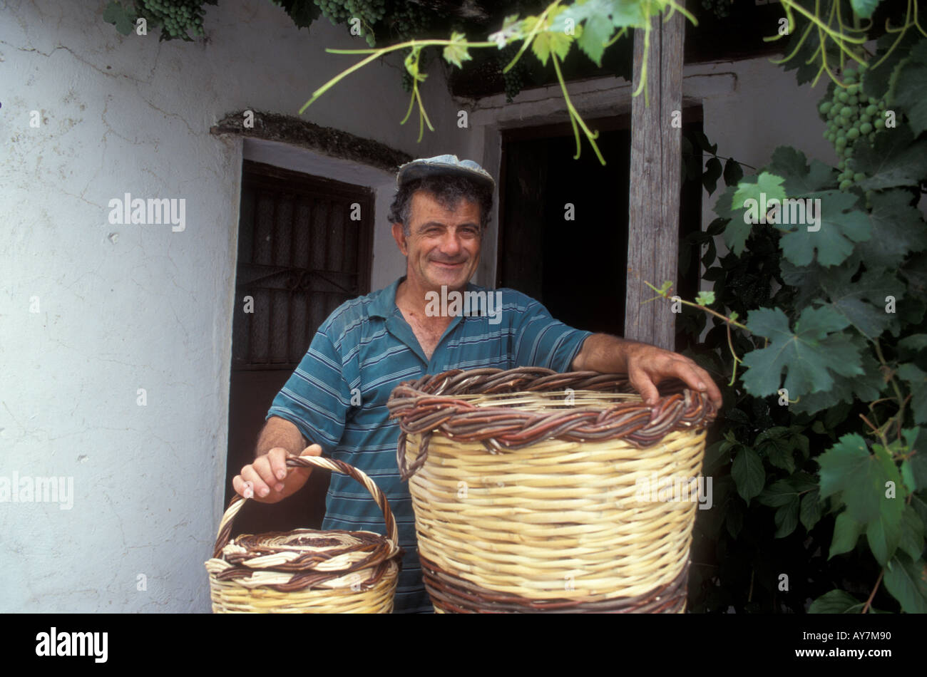 A local man with baskets, Volax village, Tinos island Greek islands ...