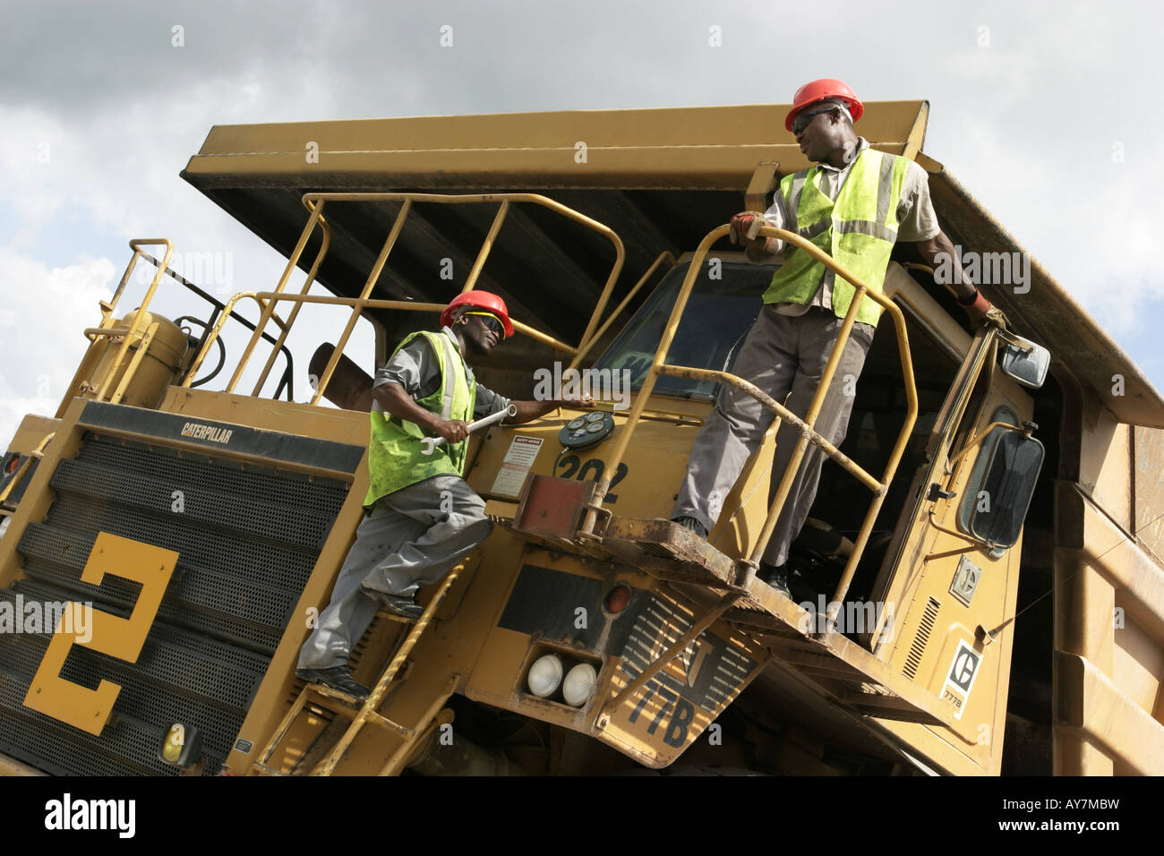 Driver and automotive engineer in discussions on Caterpillar haul truck ...