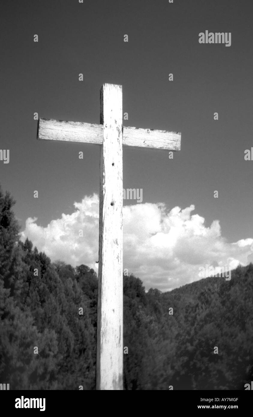 A weathered white cross rises on a hillside in New Mexico Stock Photo ...