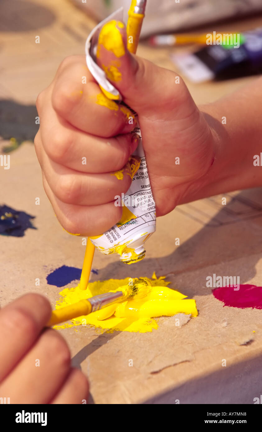 Child's hand squeezing a tube of yellow paint, at the Fine Art Days in ...