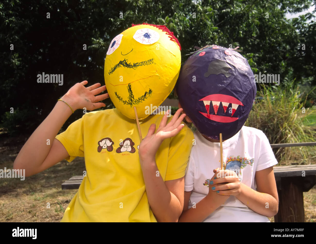 Two young art and theater students display their masks, sculpted and ...
