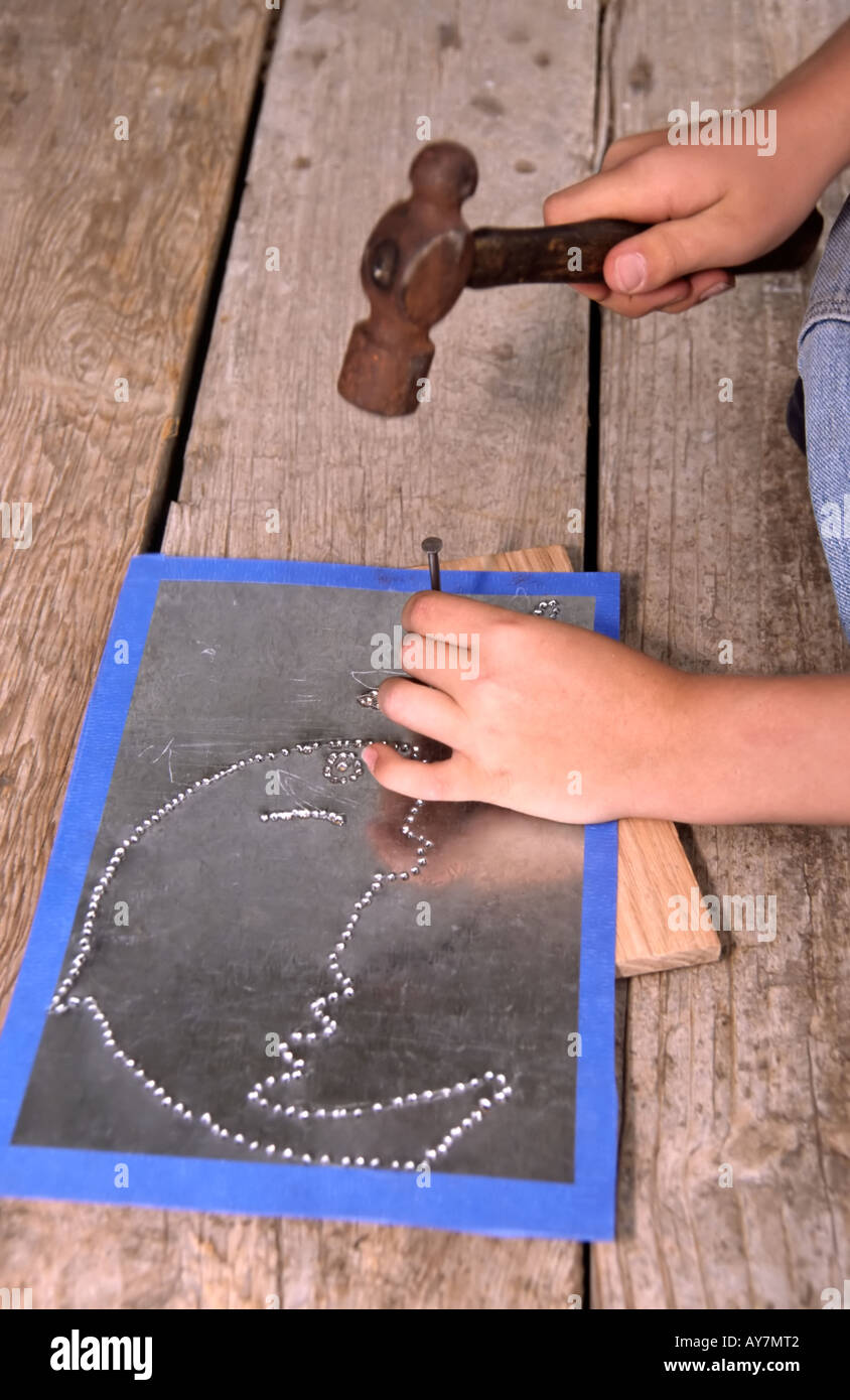 Child learning punch tin art hi-res stock photography and images - Alamy