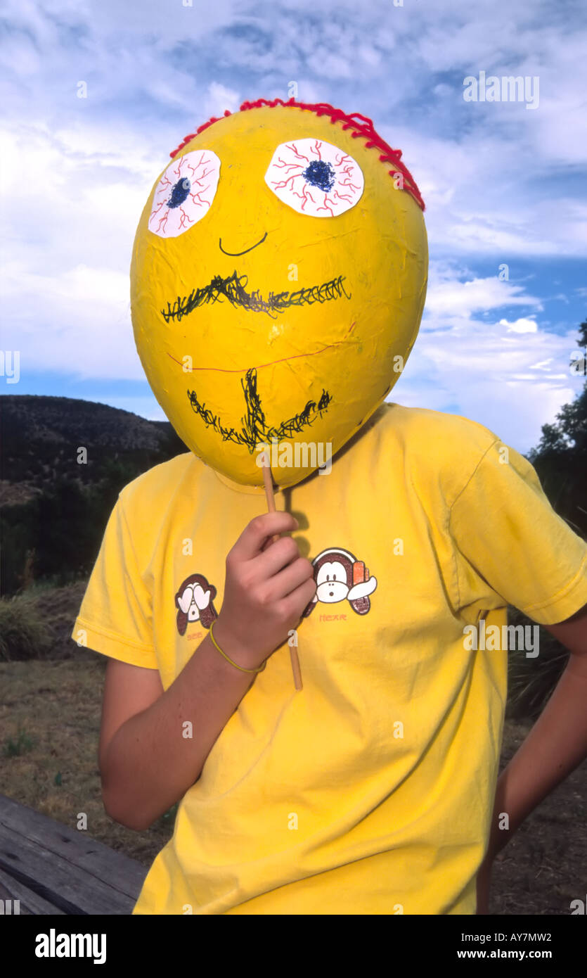 MR 597 Young artist Morgan Thomas displays her yellow papier-mache mask ...