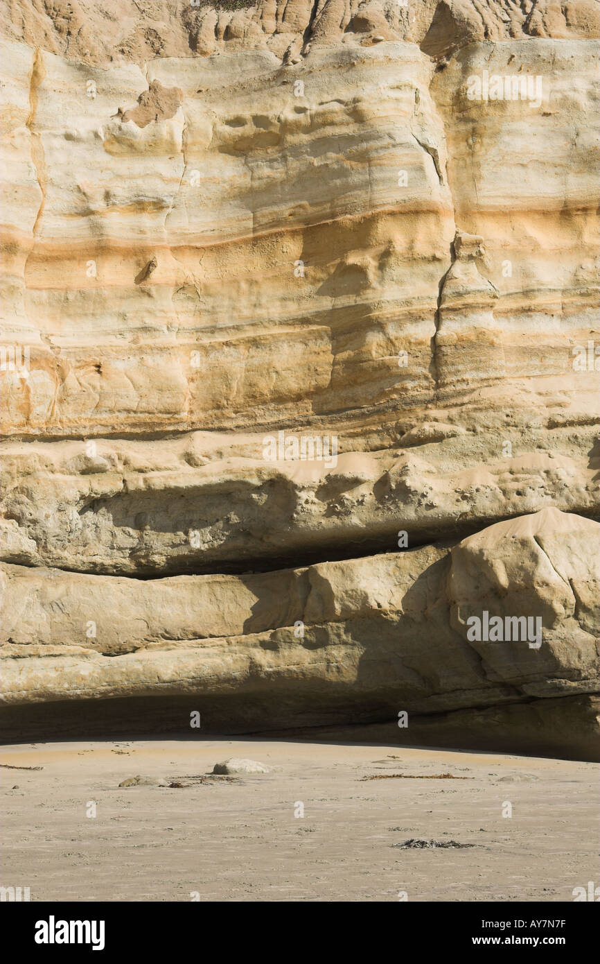 Vertical image of layered rock formations and beach Stock Photo - Alamy
