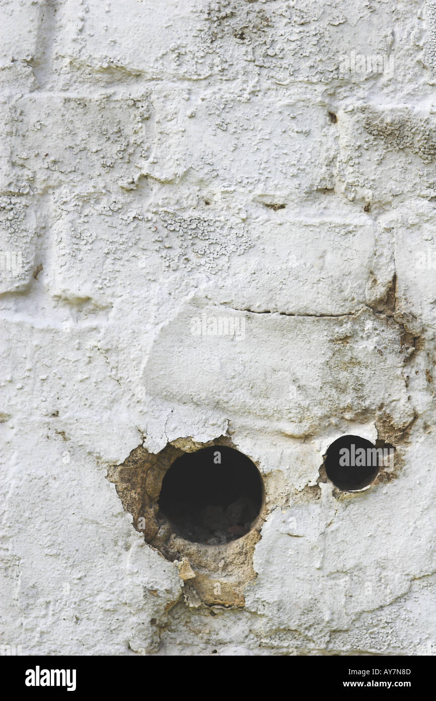 Holes in brick walls Stock Photo - Alamy