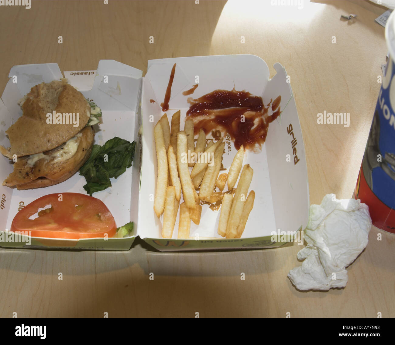 horizontal image of left over lunch in paper basket on desk Stock Photo ...