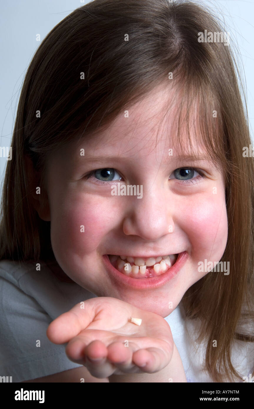 Litlle girl holding her missing tooth Stock Photo - Alamy