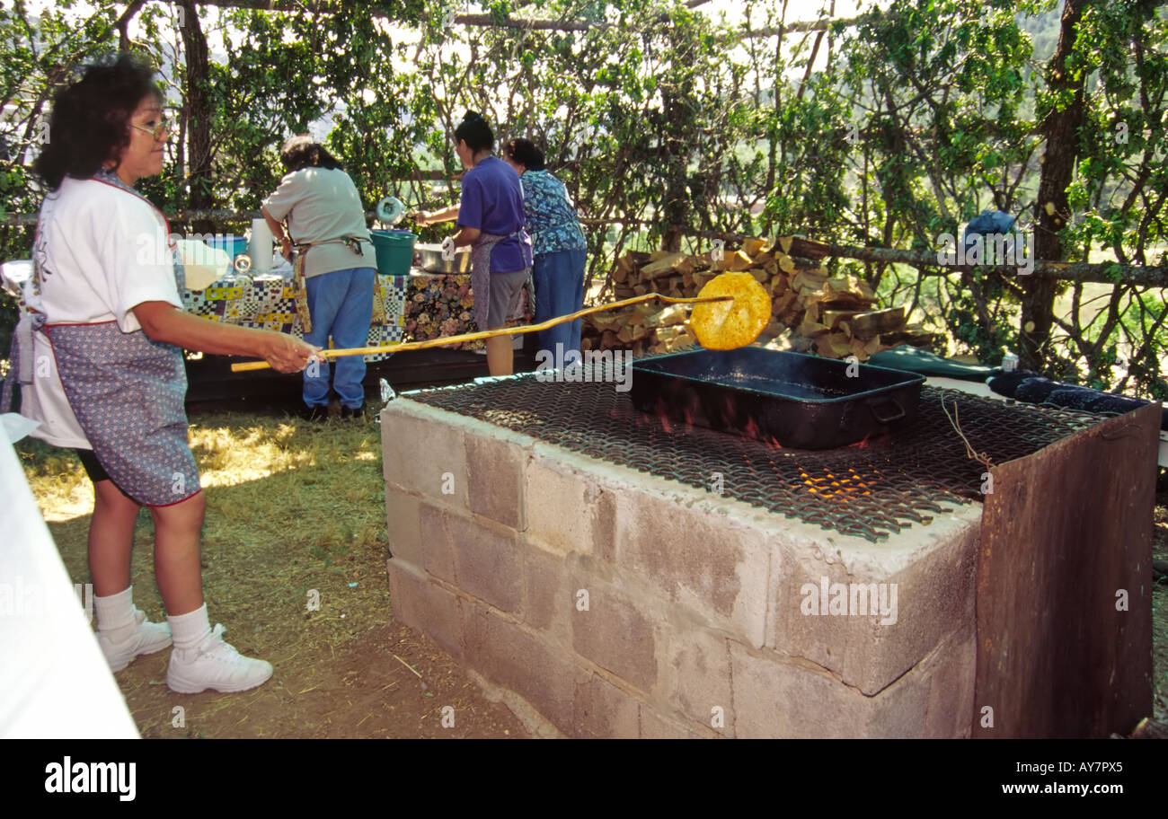 A Native-American Mescalro Apache Indian woman cooks sweet dough in hot ...