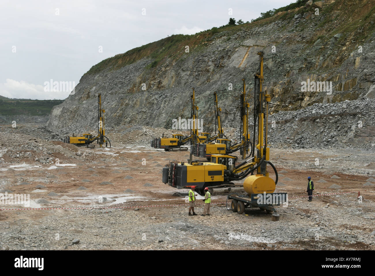 Drill rigs in opencast gold mine, preparing for blasting by drilling ...