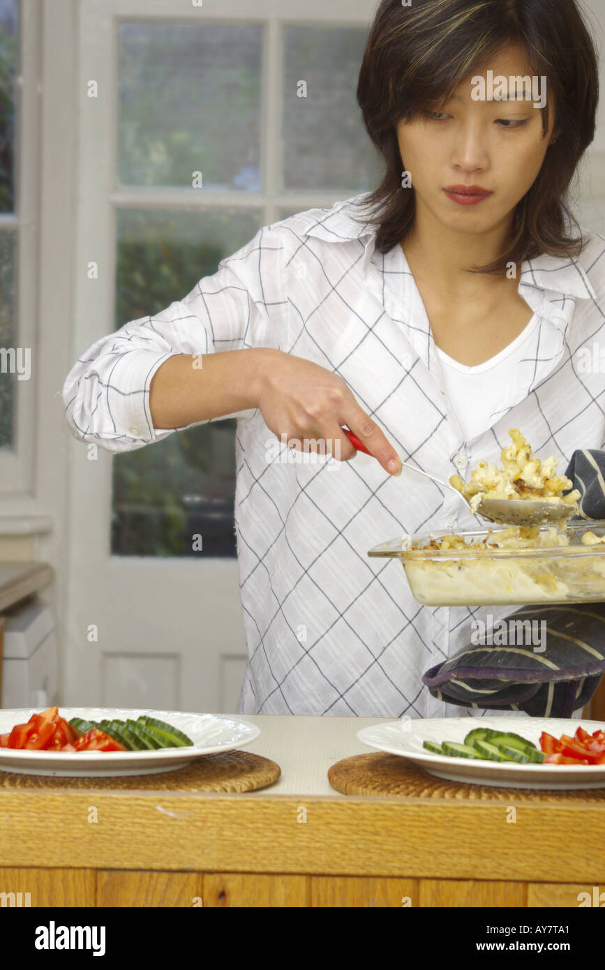 young korean asian oriental woman serving food at home Stock Photo - Alamy