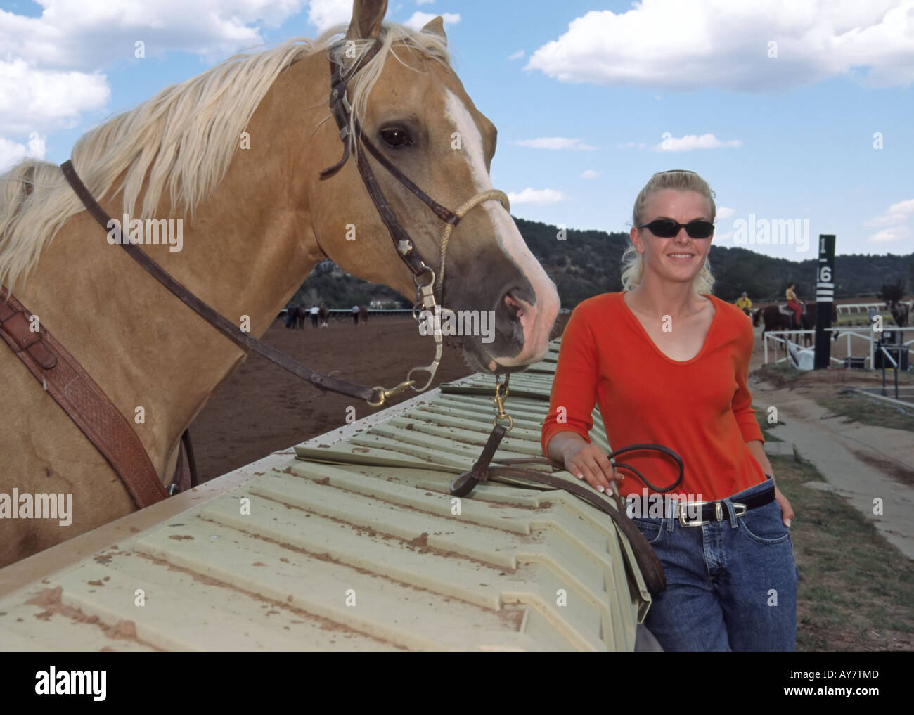 A young lady waits to watch the thoroughbred quarter horse races, at ...