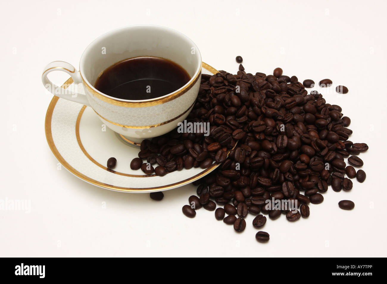 A top view shot of a cup of coffee isolated on white with coffeebeans ...