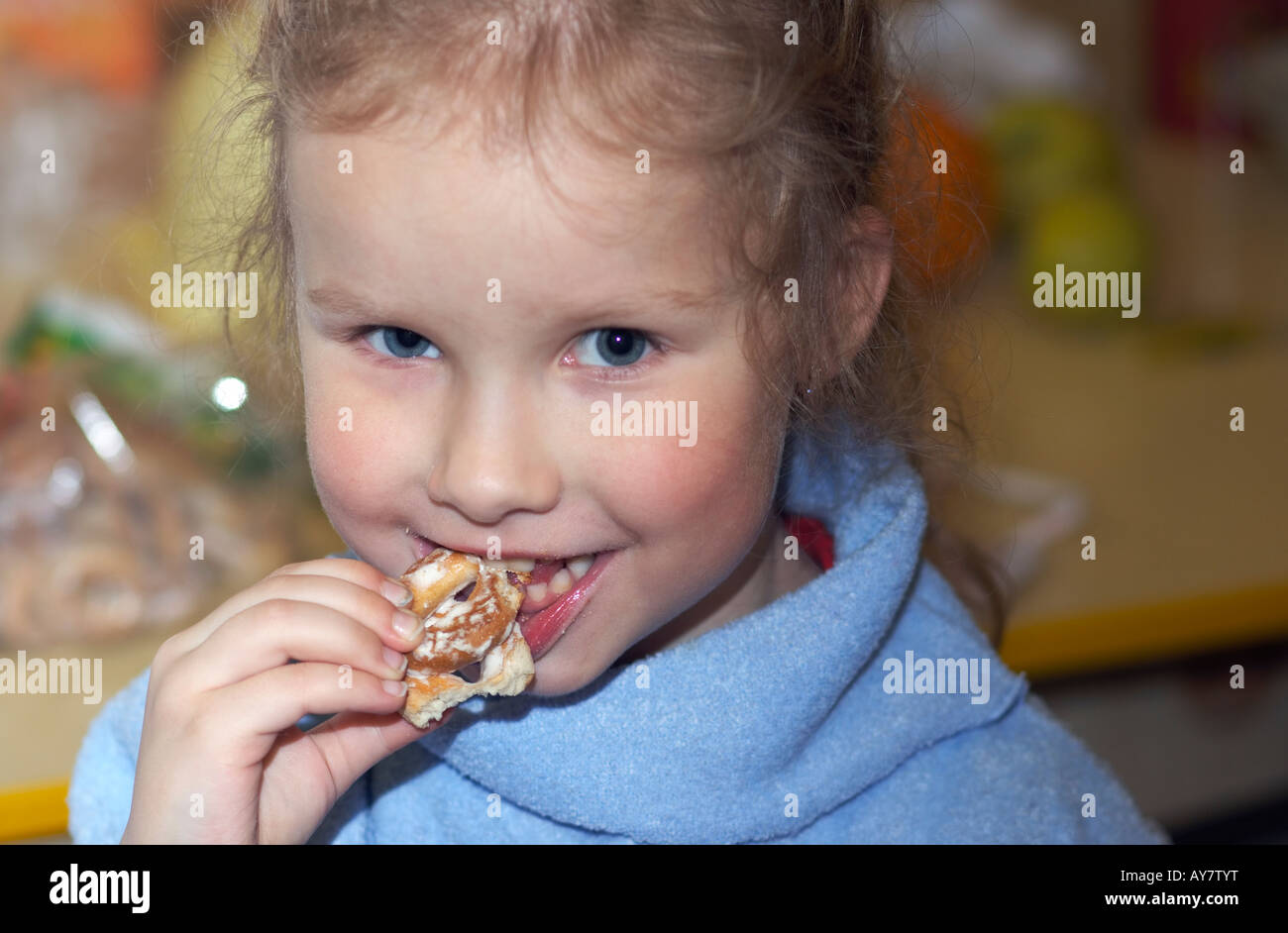 Little smile playful girl eat tasty pie (portrait Stock Photo - Alamy