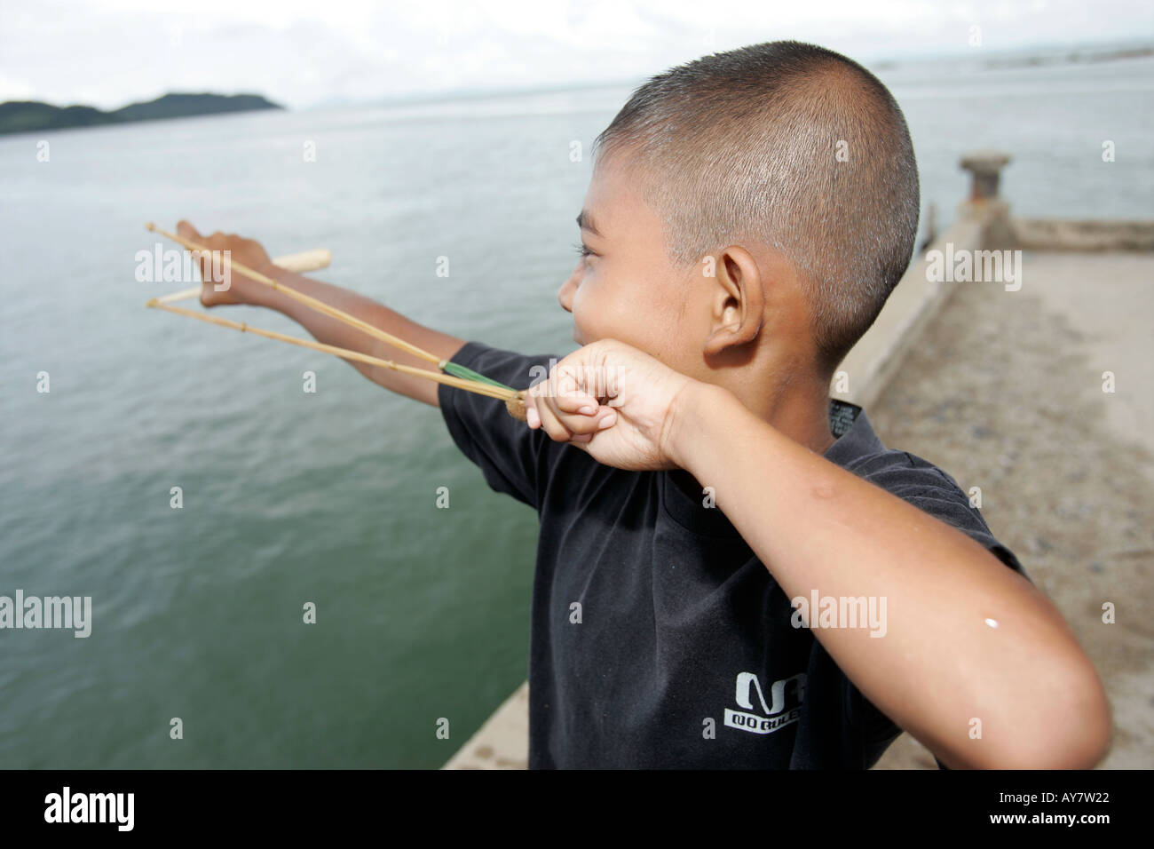 Boy aiming with slingshot hi-res stock photography and images - Alamy