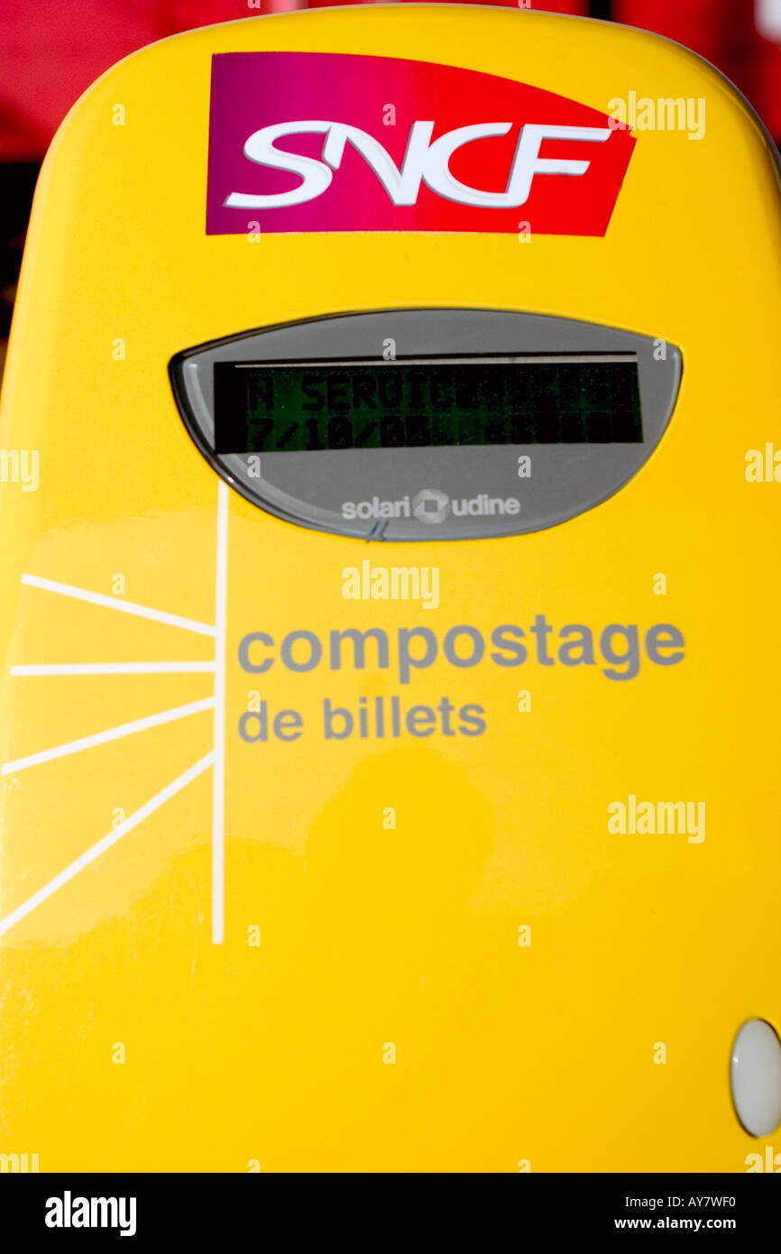 A new yellow ticket punching machine in a train station in France 2005 ...