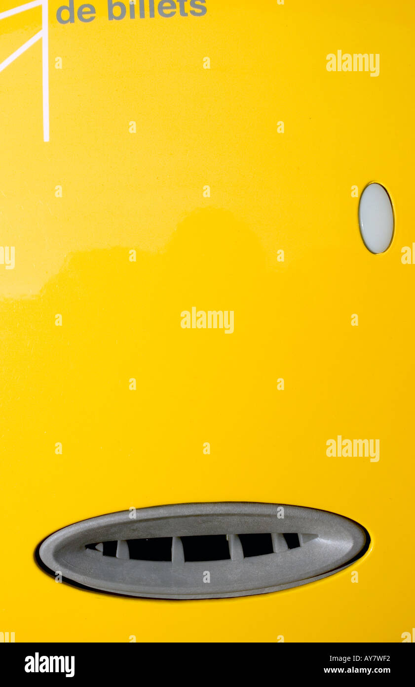 A new yellow ticket punching machine in a train station in France 2005 ...