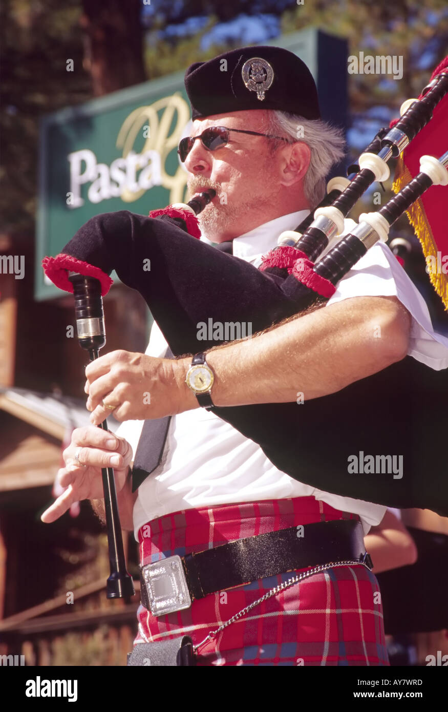 Man in red tartan kilt plays his bagpipe at the Aspenfest Parade, in ...