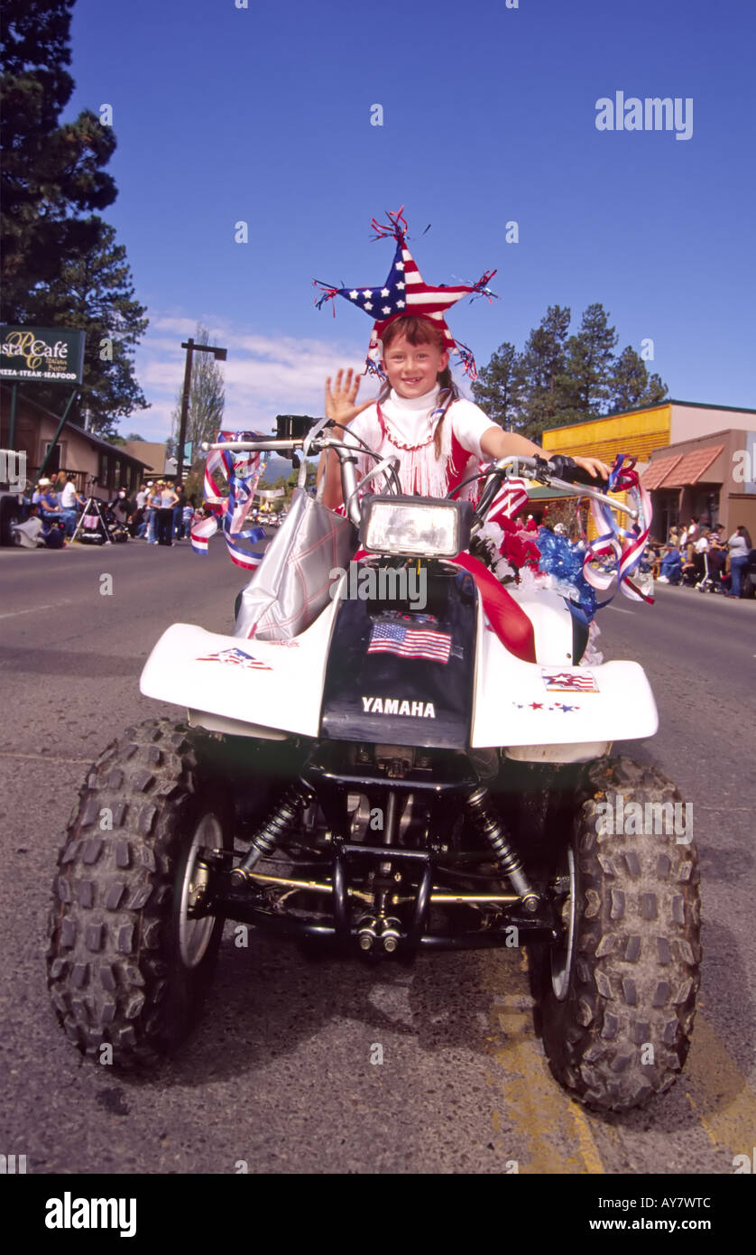 Young girl waving as she motors along on her ATV at the Aspenfest ...
