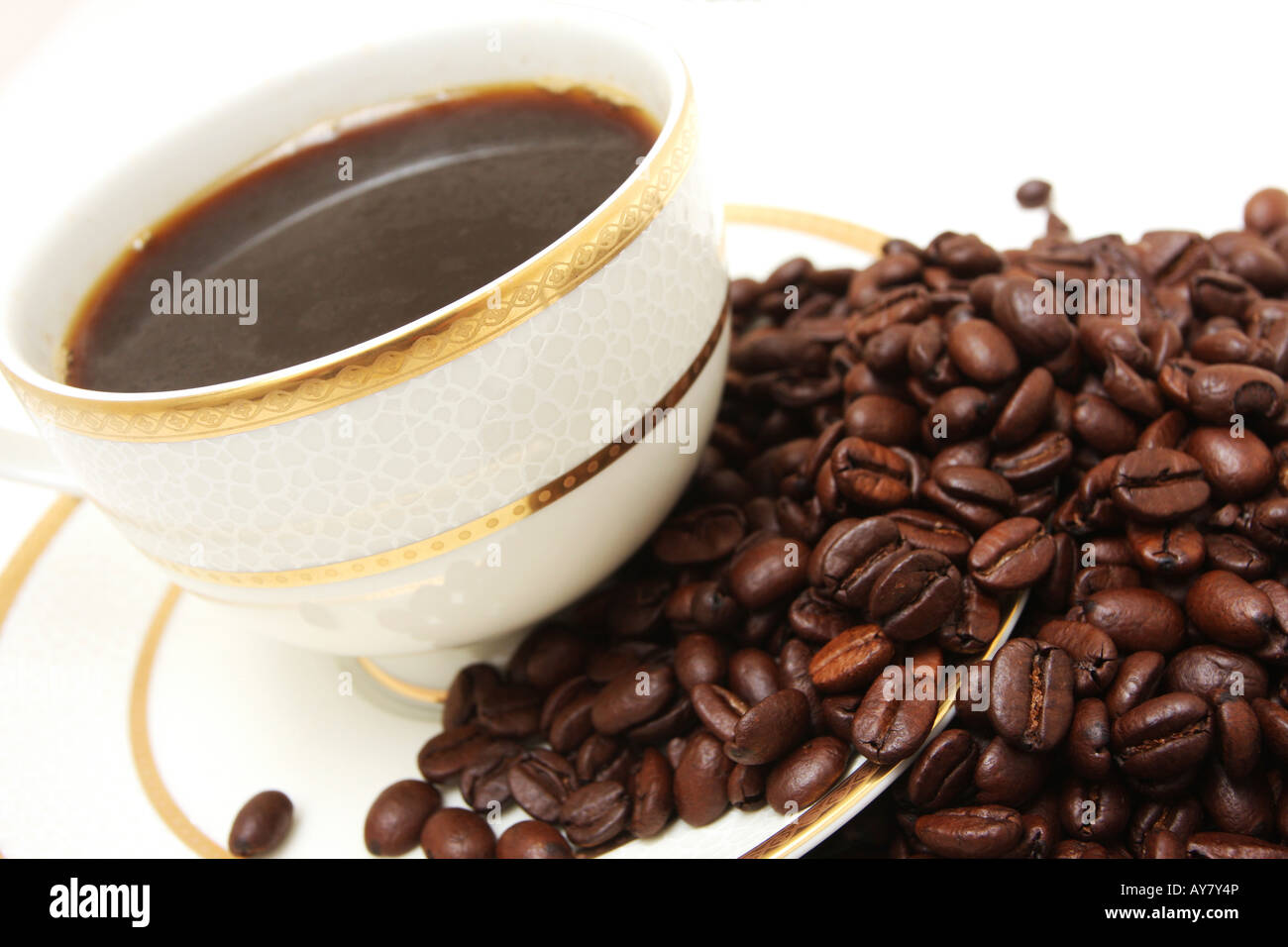 A side view shot of a cup of coffee isolated on white with coffeebeans ...