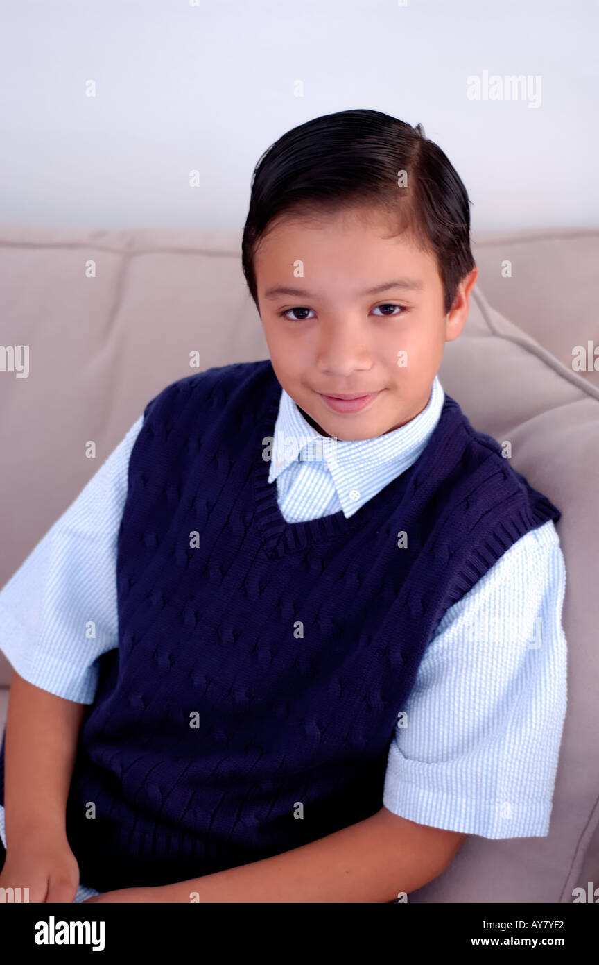 Portrait of young boy looking relaxed sitting down on a sofa Stock ...