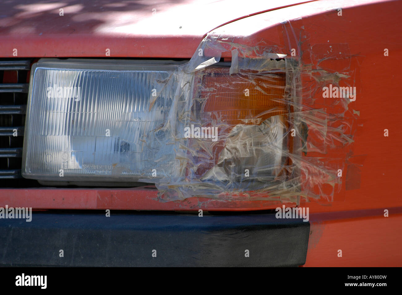 broken flash light on a red car, repair with tape Stock Photo - Alamy