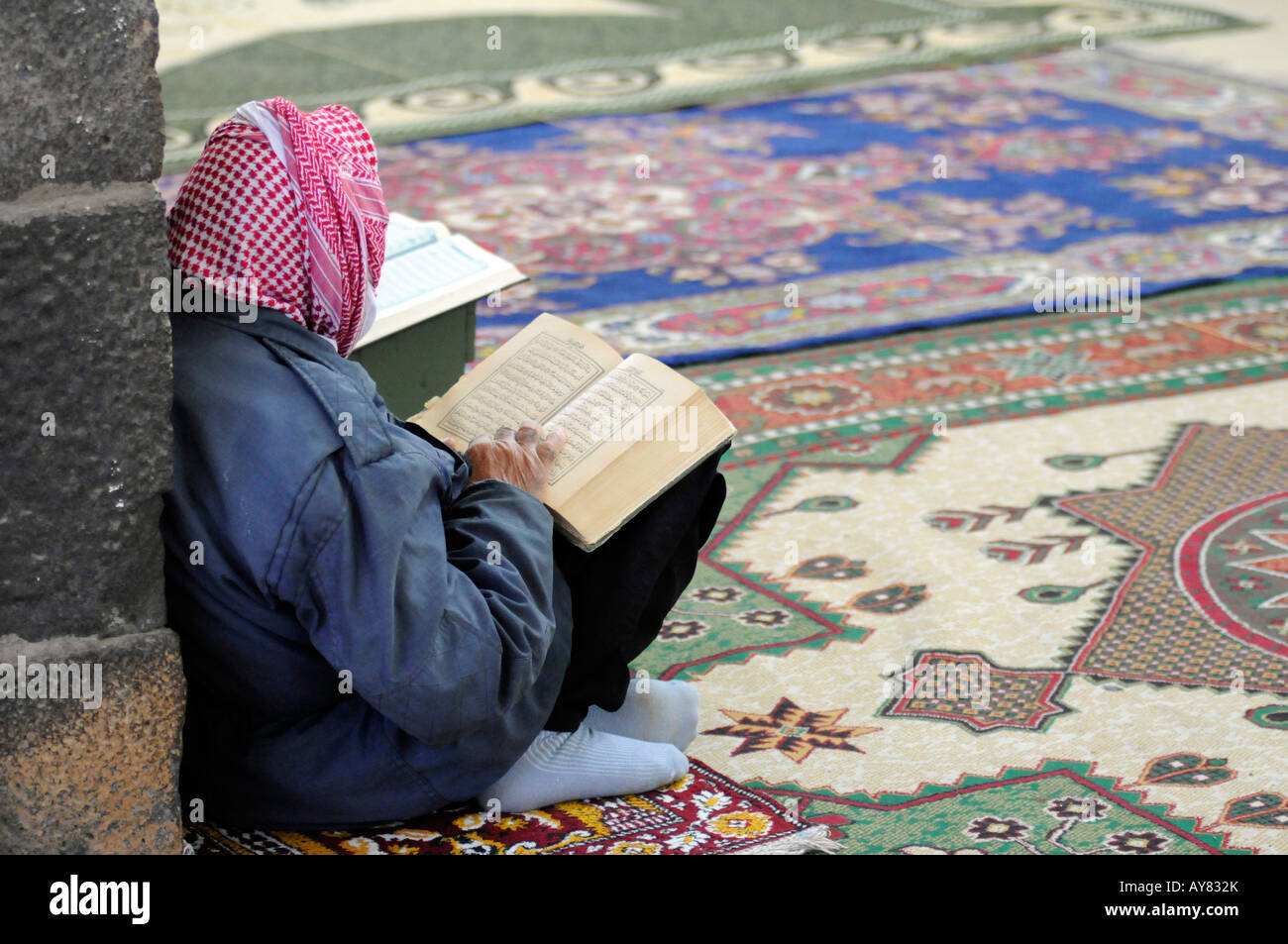 Muslim man reading quran in the mosque hi-res stock photography and ...